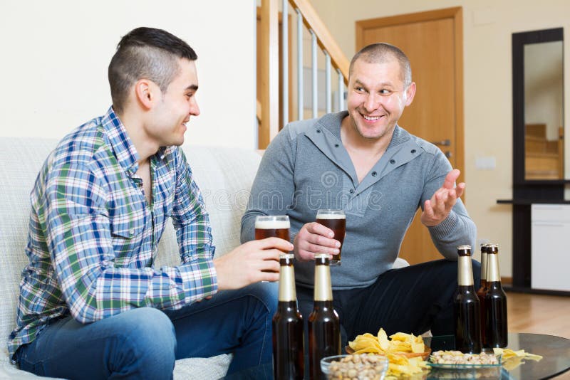 Two Friends Drinking Beer at Home Stock Image - Image of bottles ...
