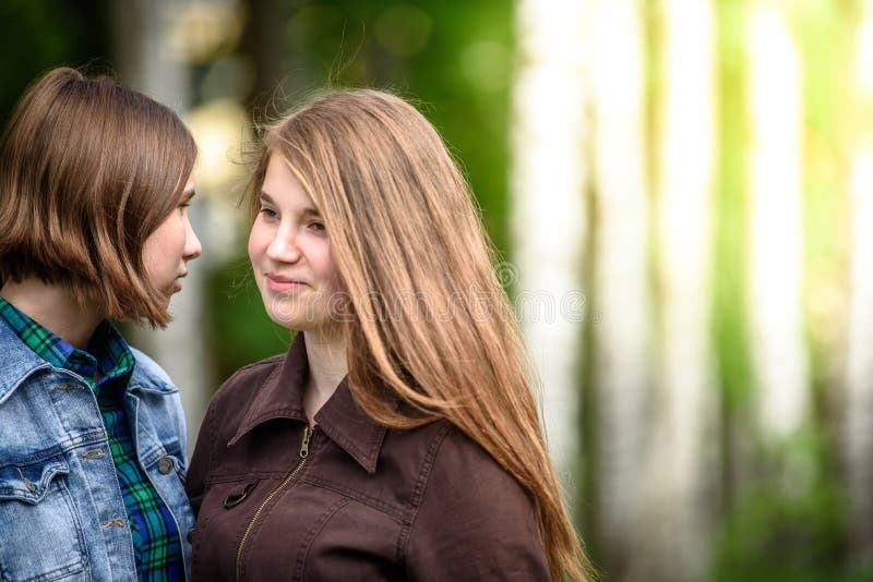 Two Friends Enjoy the Summer Sun Against the Trees Stock Image - Image ...