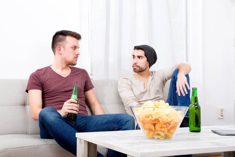 Two Friends Having a Conversation in the Living Room Stock Photo ...