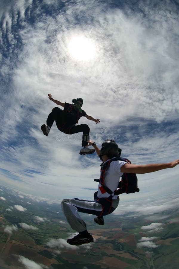 Two Friends Having Fun in Freefall. Against the Sun Stock Image - Image ...