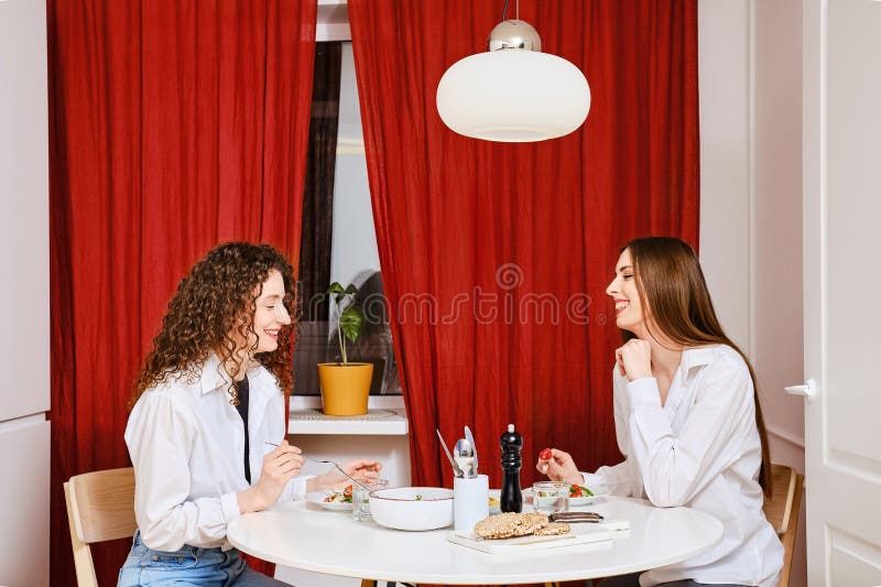 Two Friends Having Meal Together and Chatting Stock Photo - Image of ...