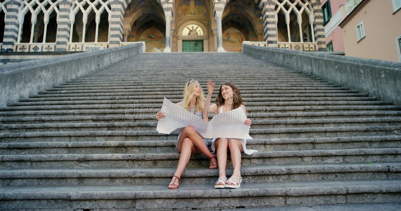 Two Friends Looking at a Map Arguing about Directions. Two Lost Women ...
