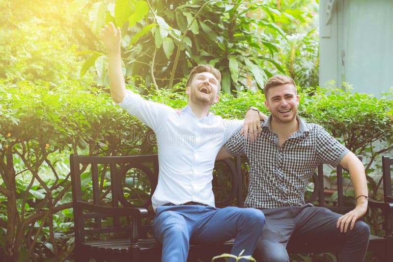 Two Friends Men Talking Standing in a Garden. Stock Image - Image of ...