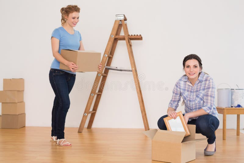 Two Friends Moving Together in a New House Stock Photo - Image of happy ...