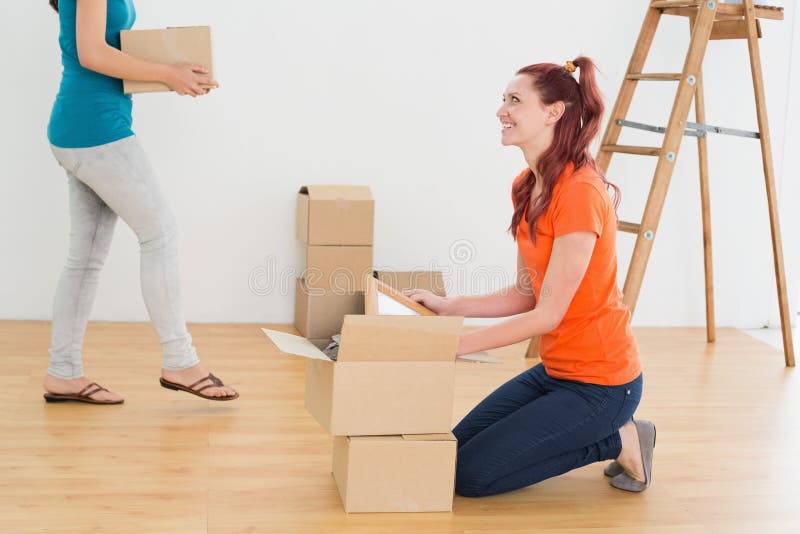 Two Friends Moving Together in a New House Stock Photo - Image of ...