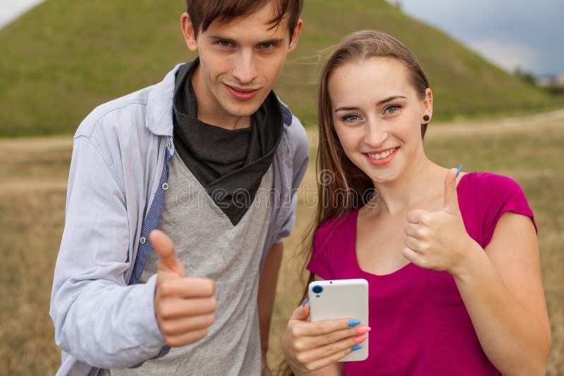 Two Friends in a Park with Mobile Phone. Positive Emotions Stock Photo ...