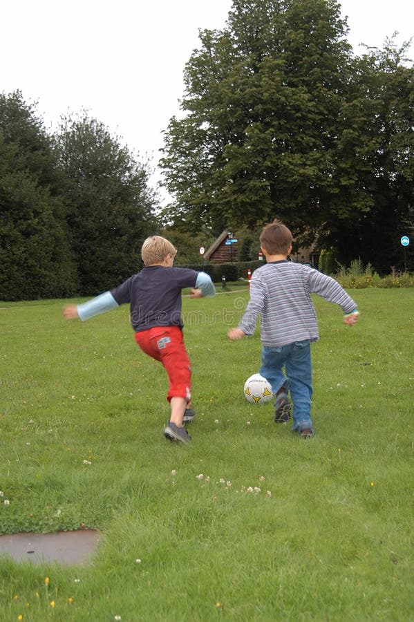 Two friends playing stock photo. Image of football, playing - 239878