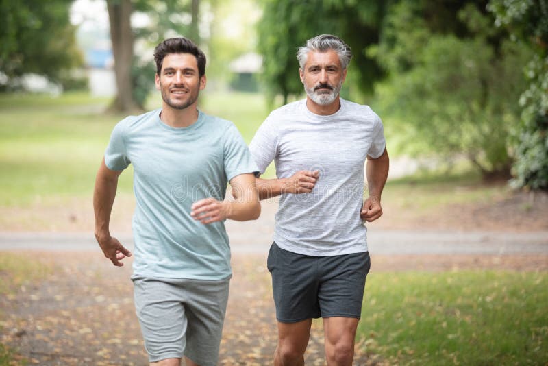 Two Friends Running through Forest on Jogging Trail Stock Image - Image ...