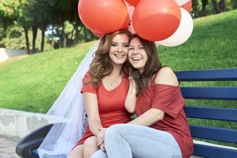 Two Friends Sitting on the Bench with Balls Stock Photo - Image of ...