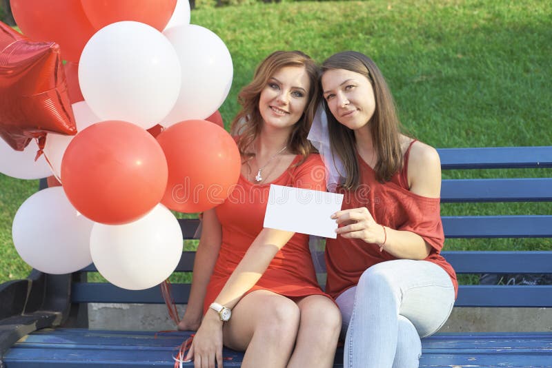 Two Friends Sitting on the Bench with Balls Stock Image - Image of ...