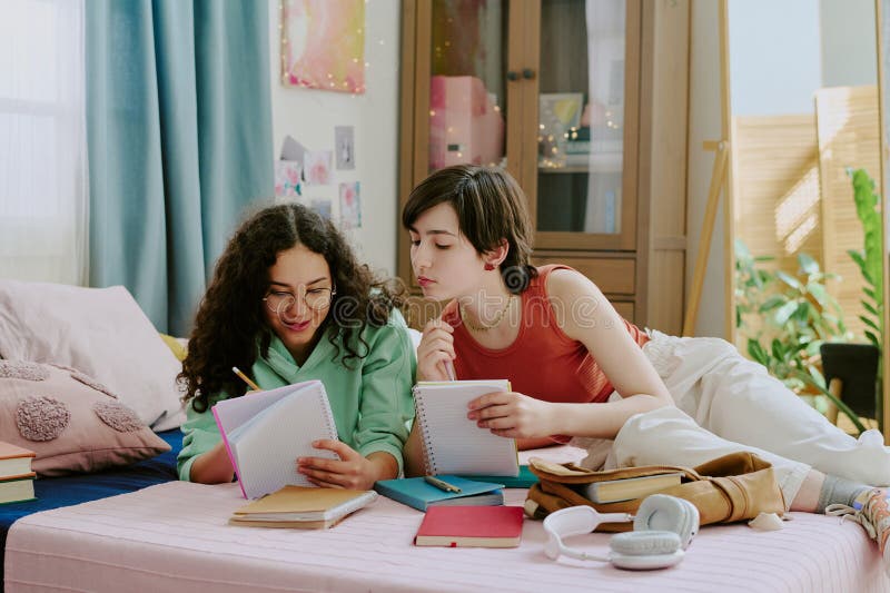 Two Friends Studying Together on Cozy Bed Stock Image - Image of ...