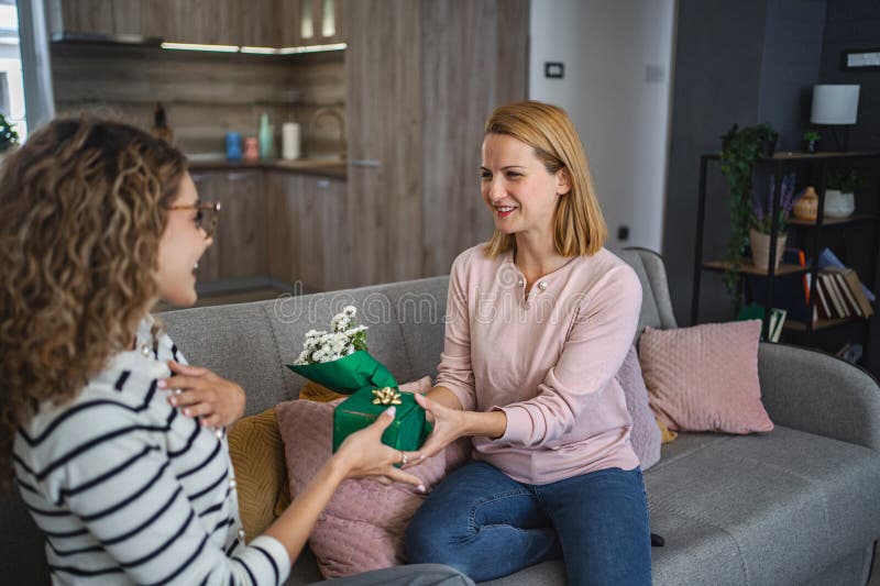 Two Friends Sitting on a Couch Exchanging a Present Stock Image - Image ...