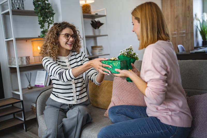 Two Friends Sitting Couch One Holding Present Stock Photos - Free ...