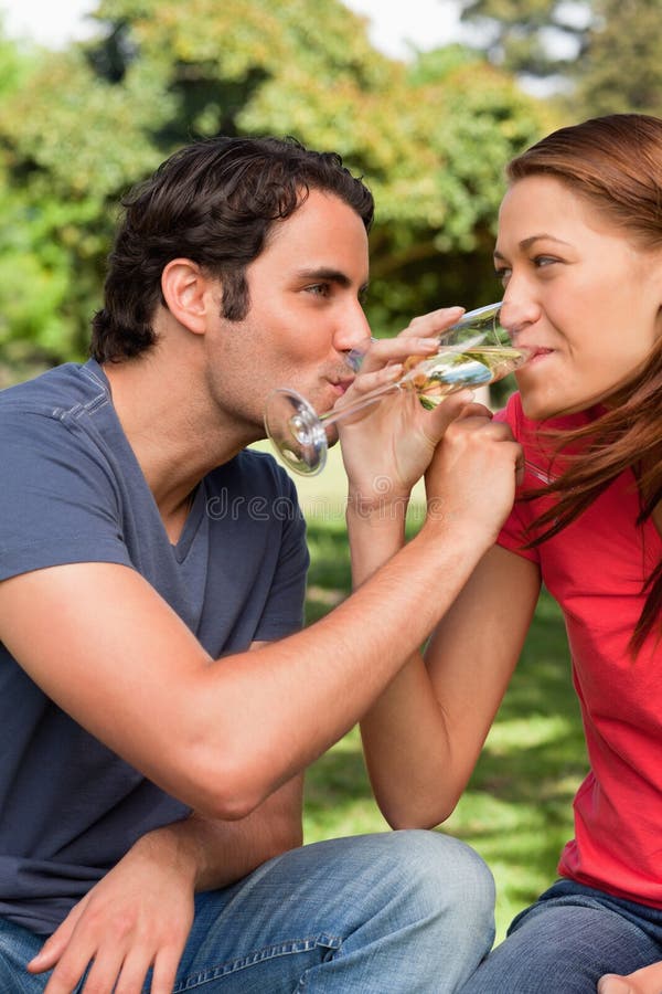 Two Friends Smiling As they Link Their Arms Together while Drink Stock ...