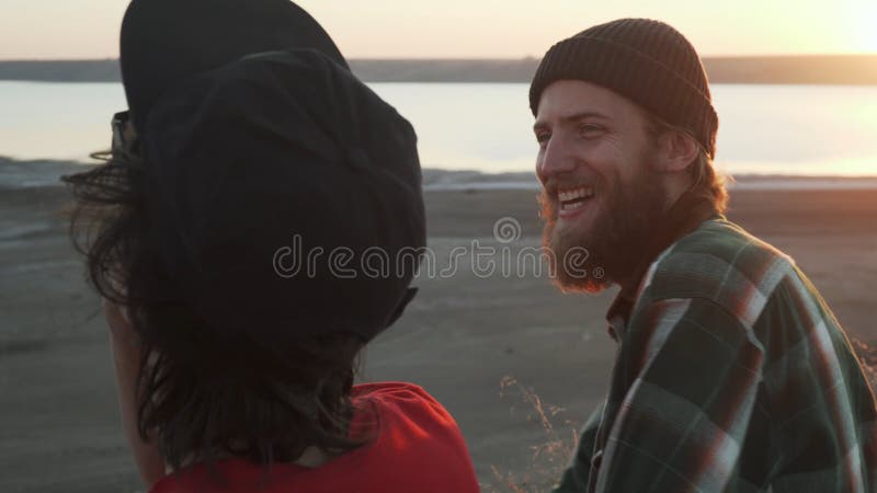 Two Friends Smoking Joint with Weed at Seashore at Sunset Stock Photo ...