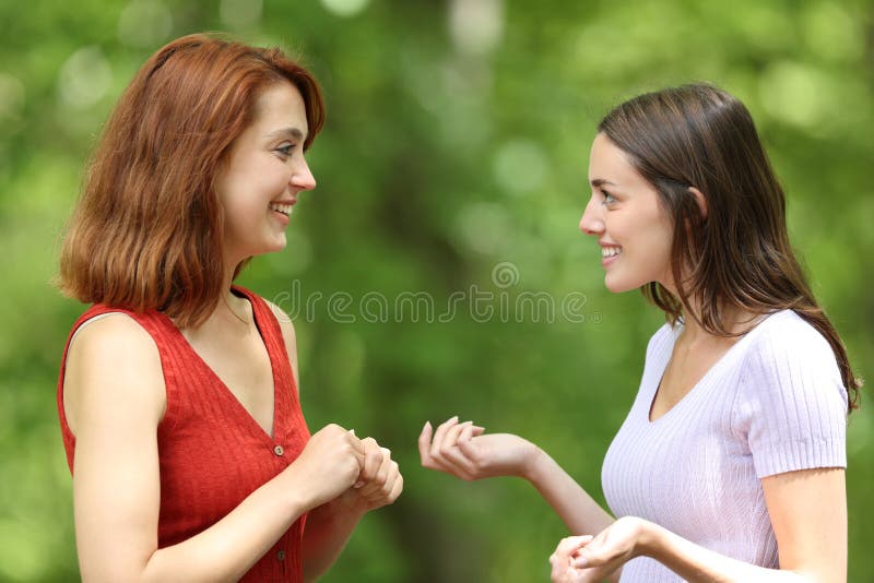 Two Friends Talking in a Green Park Stock Image - Image of conversation ...