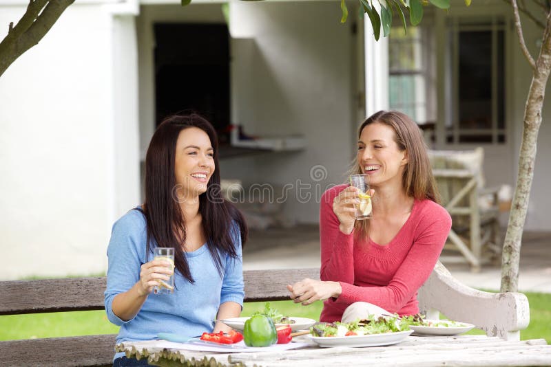 Two Women Friends Sitting Outside Garden Having Lunch Stock Photos ...