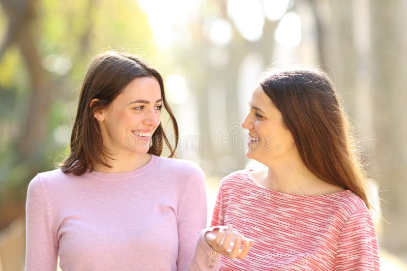 Two Friends Talking while Walking in the Street Stock Photo - Image of ...