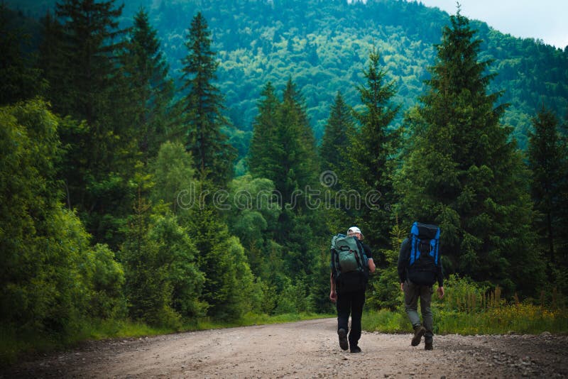 Two Friends Travel in Mountains with Backpacks Stock Image - Image of ...