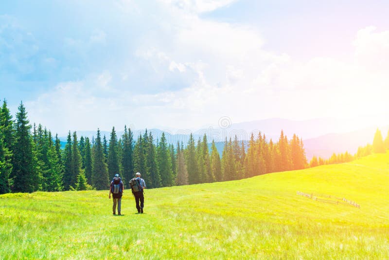 Two Friends Travel in Mountains with Backpacks Stock Photo - Image of ...