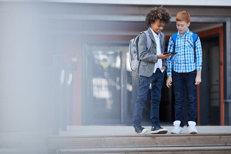 Two Friends Using Phone after School Stock Image - Image of holding ...