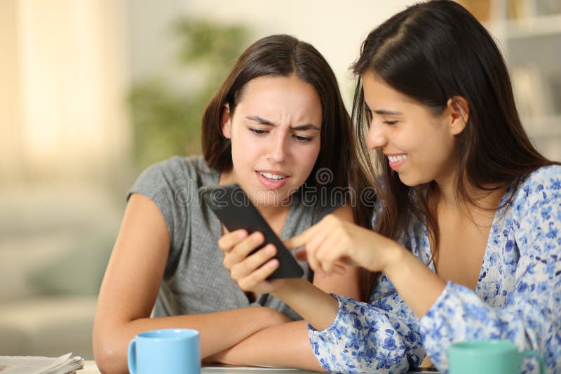 Two Friends Watching Funny Media Content on Phone Stock Photo - Image ...