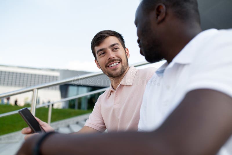 Two Friends Watching Something on the Phone and Smiling Stock Image ...