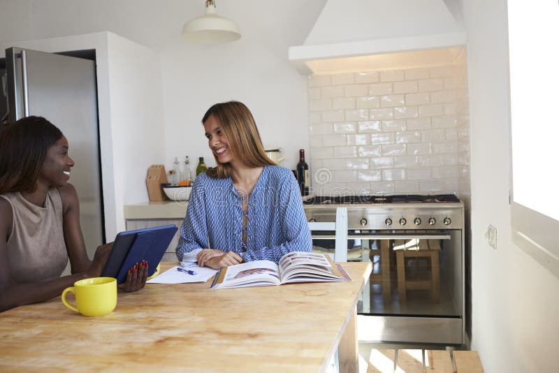 Two Friends Working at the Kitchen Table Look at Each Other Stock Photo ...