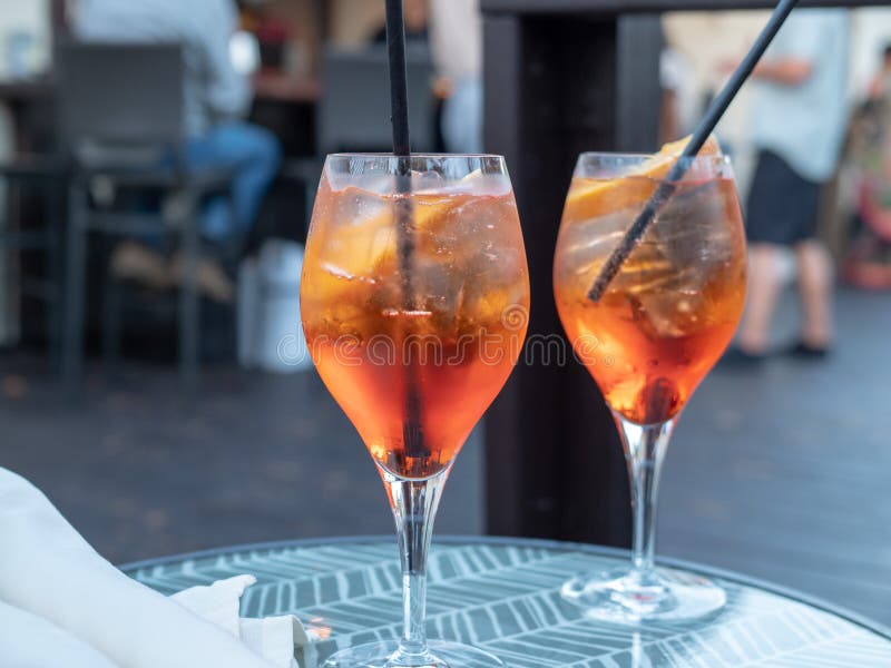 Two Full Spritz Drinks Sitting on Outdoor Table in Restaurant Stock ...