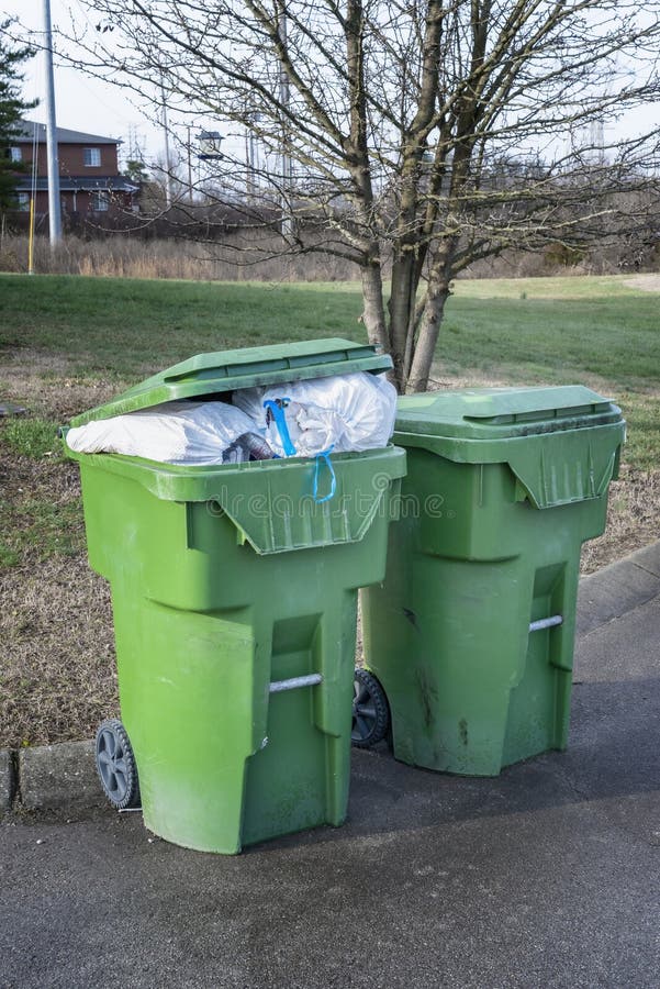 Two Full Trash Containers by the Curb Stock Image - Image of vertical ...