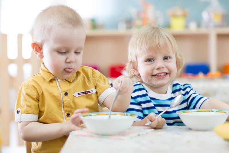 Two Funny Smiling Little Kids Eating in Kindergarten Stock Photo ...