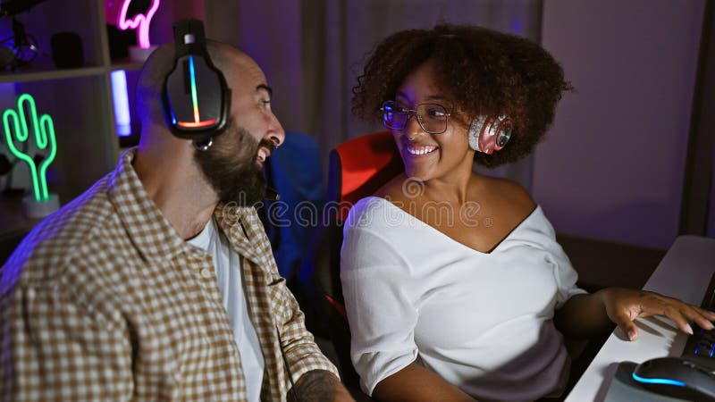 Two Gamers Smiling Confident Sitting on Table Speaking at Gaming Room ...