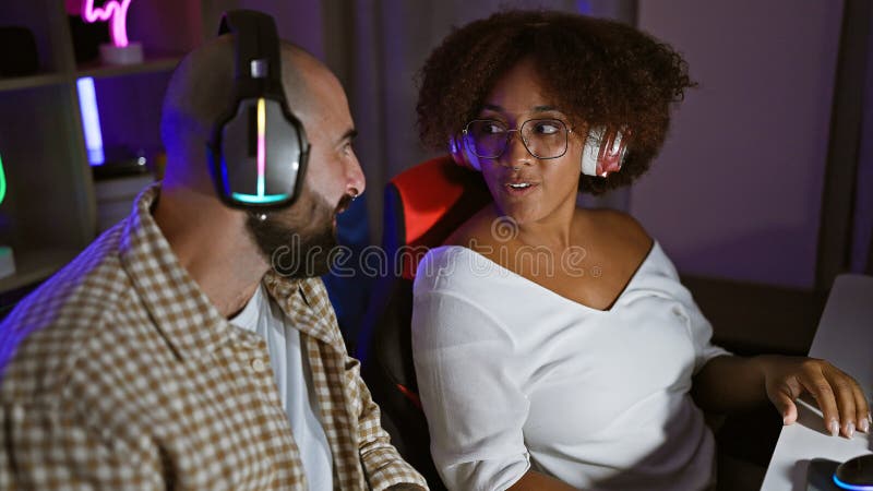Two Gamers Smiling Confident Sitting on Table Speaking at Gaming Room ...