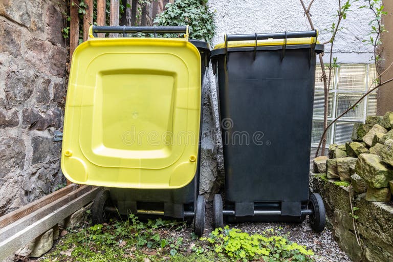 Two Garbage Cans for Plastic are in the Yard Stock Photo - Image of ...
