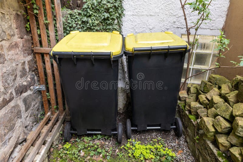 Two Garbage Cans for Plastic are in the Yard Stock Image - Image of ...