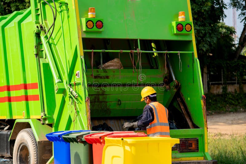 Two Garbage Men Working Together on Emptying Dustbins for Trash Removal ... Two Garbage Men Working Together on Emptying Dustbins for Trash Removal ...