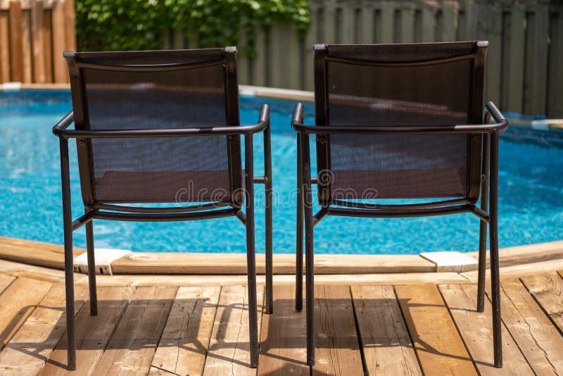 Two Garden Chairs on the Wooden Deck in Front of the Pool Stock Image ...