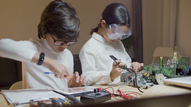 Two Geek Children Sitting at Desk and Doing Project Work Stock Footage ... Two Geek Children Sitting at Desk and Doing Project Work Stock Footage ...