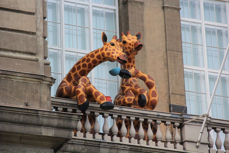 Two Giant Spotted Giraffes Drinking Tea on an Open Balcony Stock Image ...
