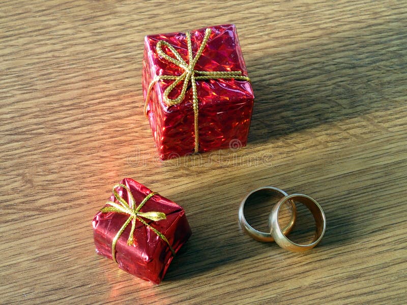 Two Gifts and Gold Wedding Rings Stock Image - Image of golden, gifts ...