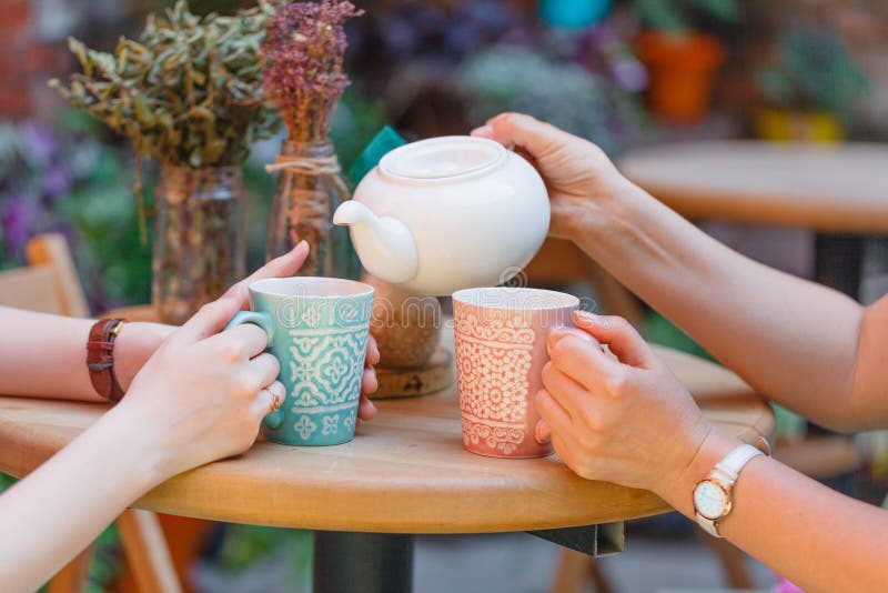 Two Girl-friends Talk and Drink Tea in Cafe, Outdoors Stock Image ...