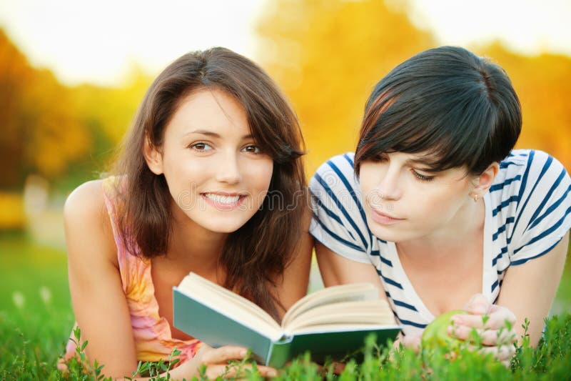 Two girl read a book stock photo. Image of nature, cute - 19119456
