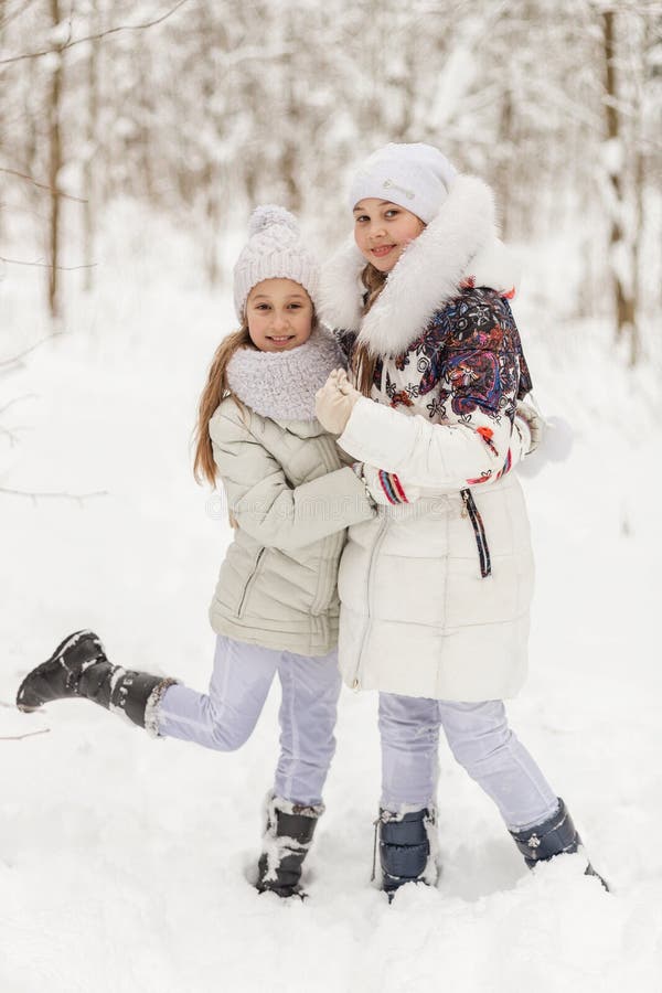 Two Girlfriends Playing in a Winter Forest. Stock Image - Image of ...
