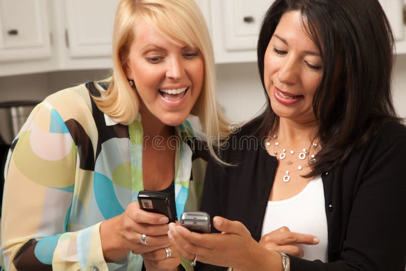 Two Girlfriends Sharing with Their Cell Phones Stock Image - Image of ...