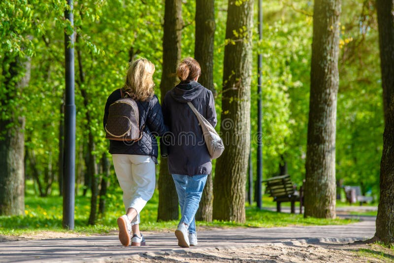 Girlfriends Walk Along a Path in the Park Stock Photo - Image of ...