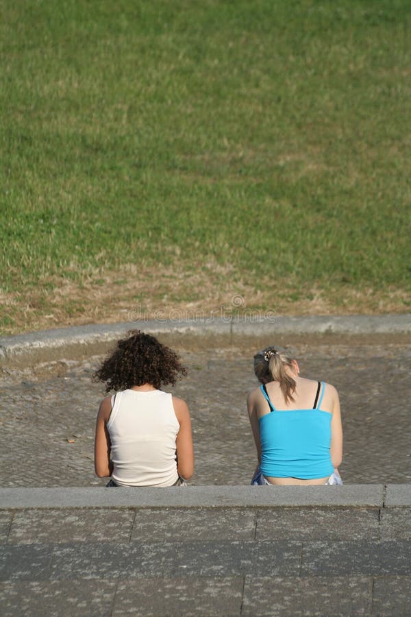 Two girls stock image. Image of facing, books, concrete - 887637