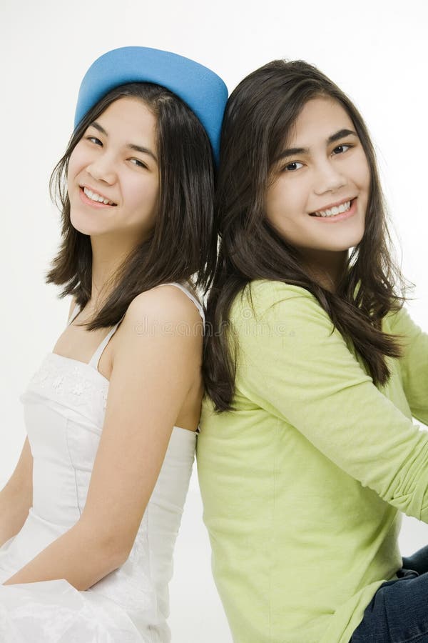 Two Girls Back To Back, Smiling Stock Photo - Image of sitting, teens ...
