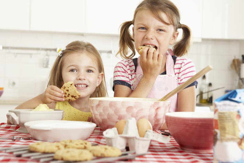 Two Girls Baking in Kitchen Stock Image - Image of female, camera: 55897175