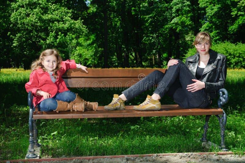 Two girls on the bench stock photo. Image of family, people - 14601220
