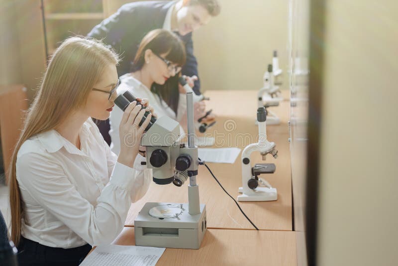 Two Girls and a Boy Work with Microscopes Stock Image - Image of female ...